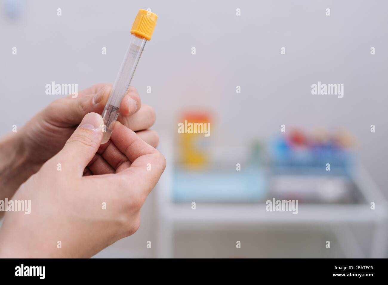 Close-up of doctor in the laboratory with a blood tube for analysis ...