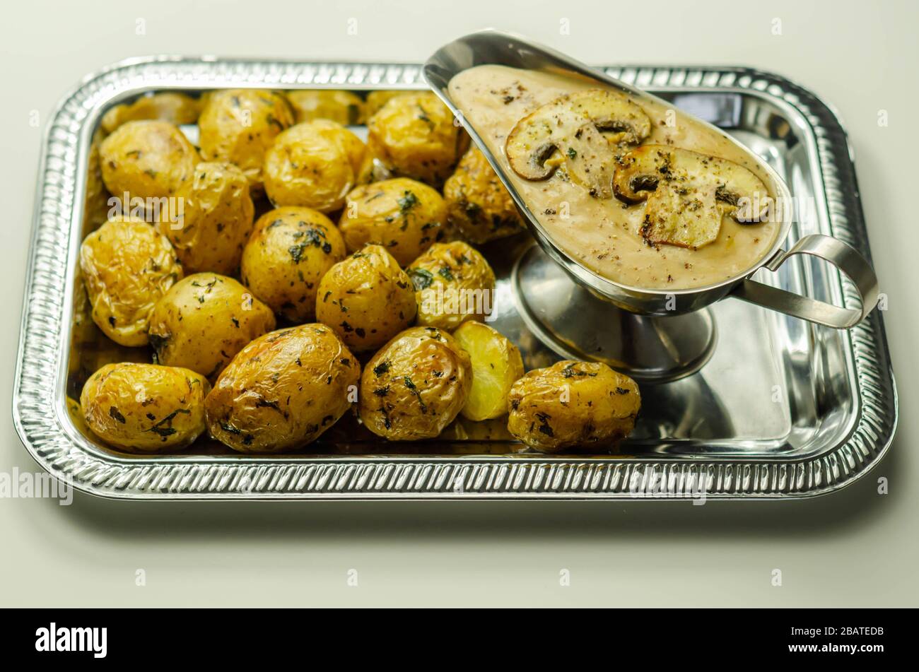 Mini jacket potatoes with mushrooms sauce on the silver tray, delicious ...