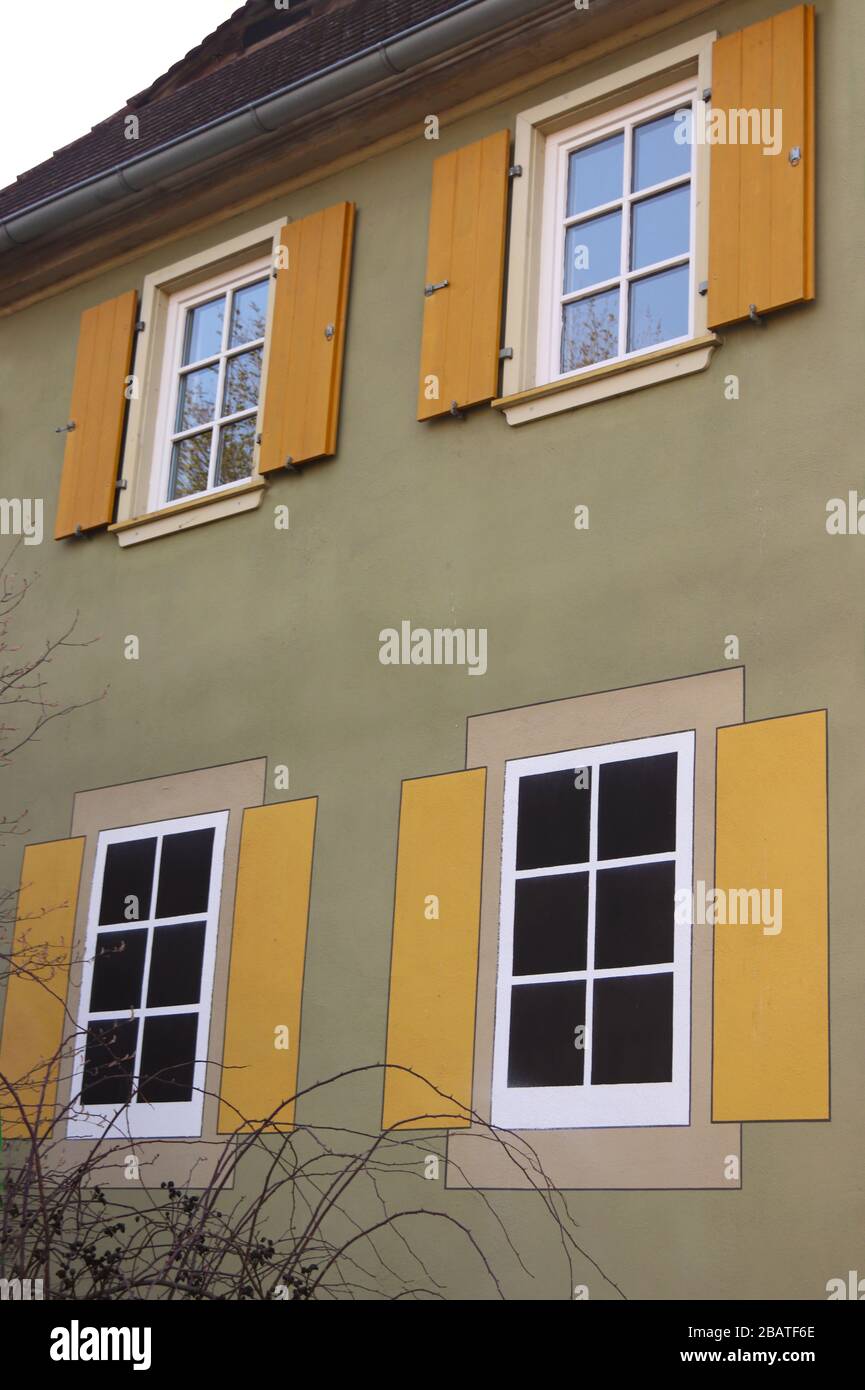 facade of an old house with real windows and with painted windows Stock ...