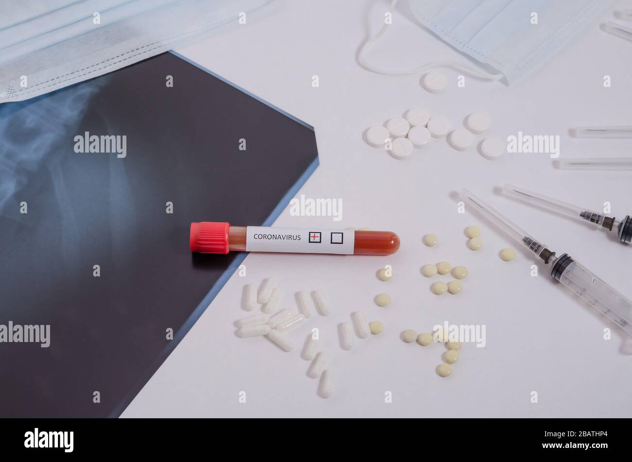 Positive blood test for coronavirus, lung x-ray, surgical medical mask ...