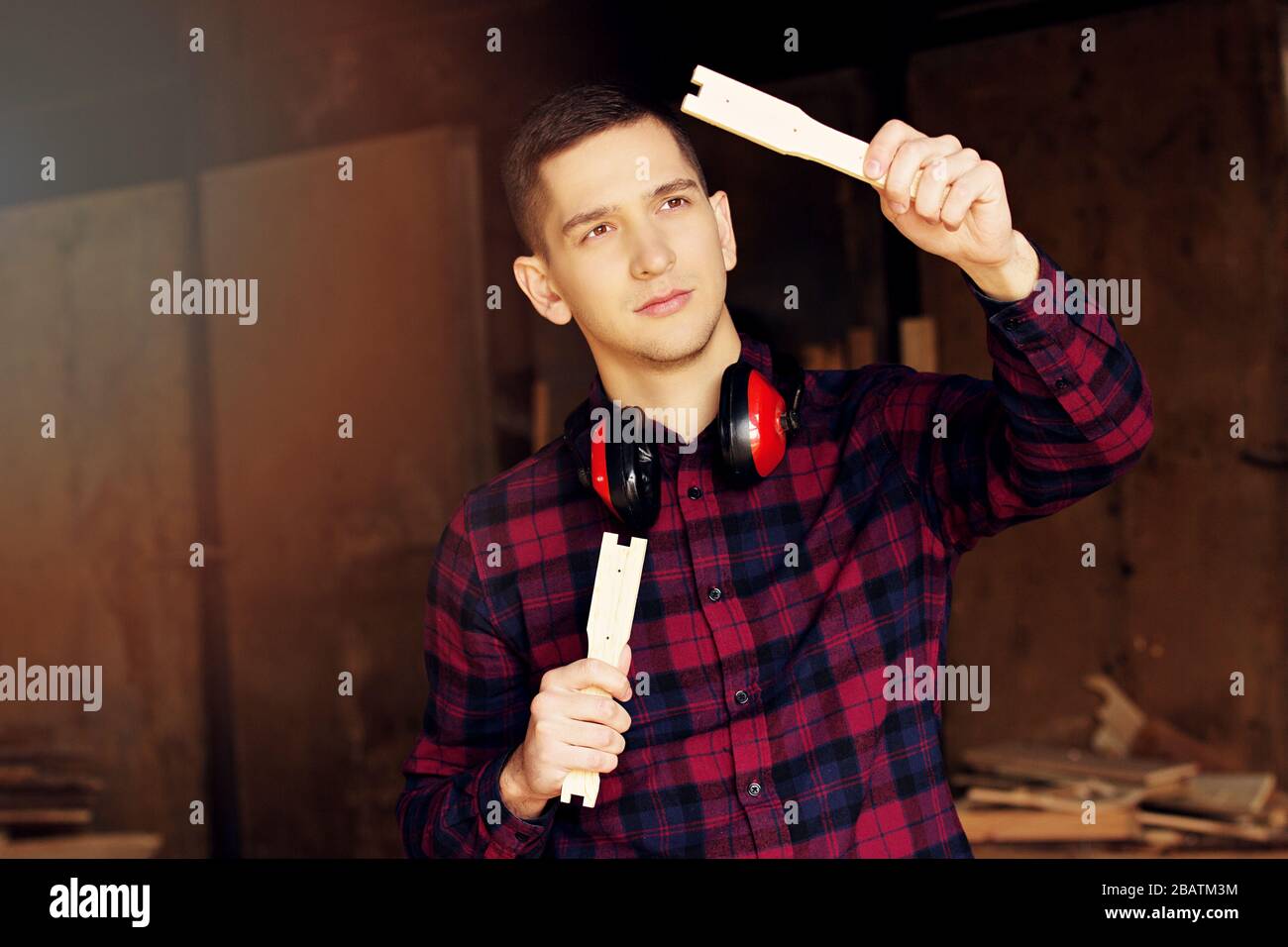 Workman at the sawmill. Young hardworking man Stock Photo - Alamy