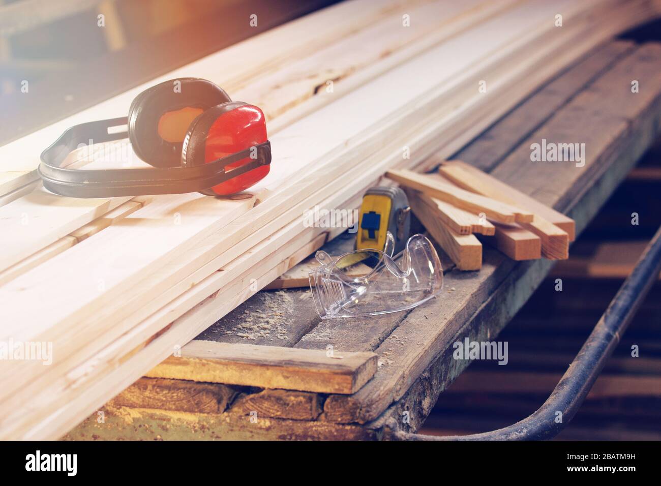 Workman at the sawmill. Young hardworking man Stock Photo - Alamy