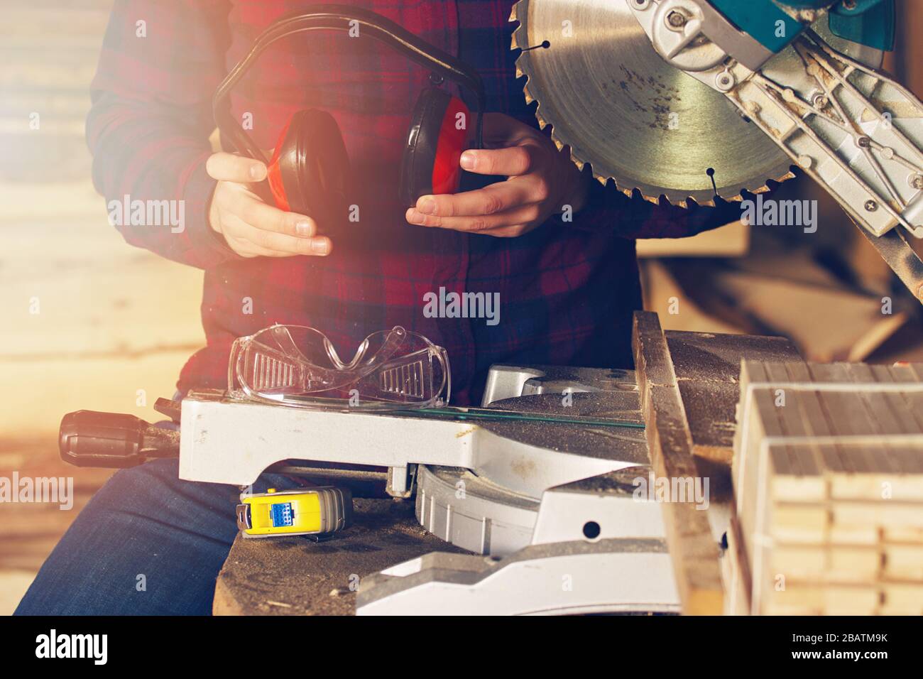 Workman at the sawmill. Young hardworking man Stock Photo - Alamy