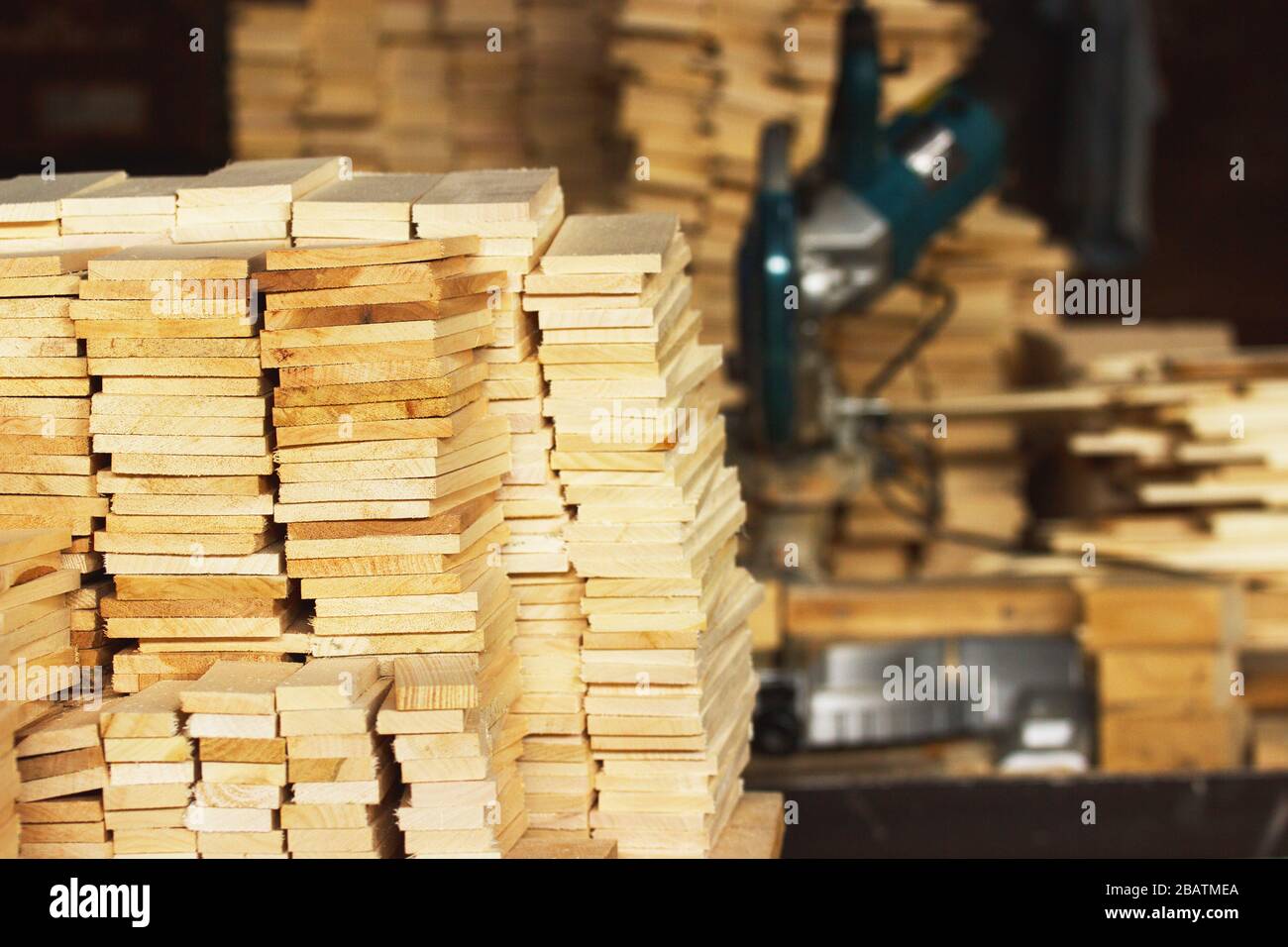 Workman at the sawmill. Young hardworking man Stock Photo - Alamy