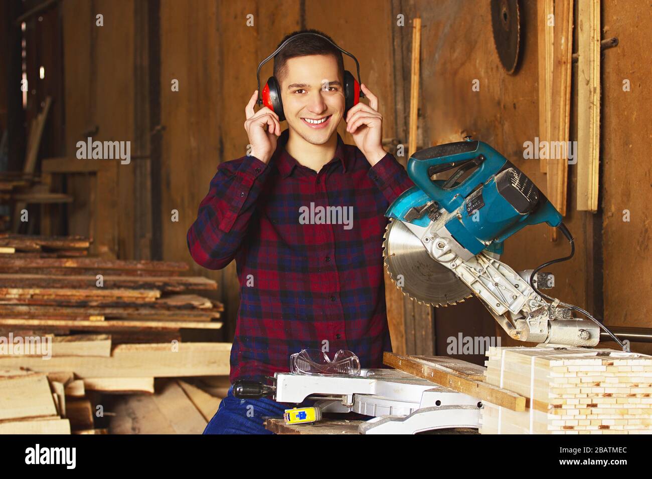 Workman at the sawmill. Young hardworking man Stock Photo - Alamy