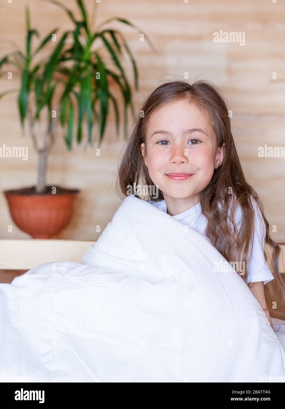 Portrait of a smiling girl waking up early in the morning in a country ...