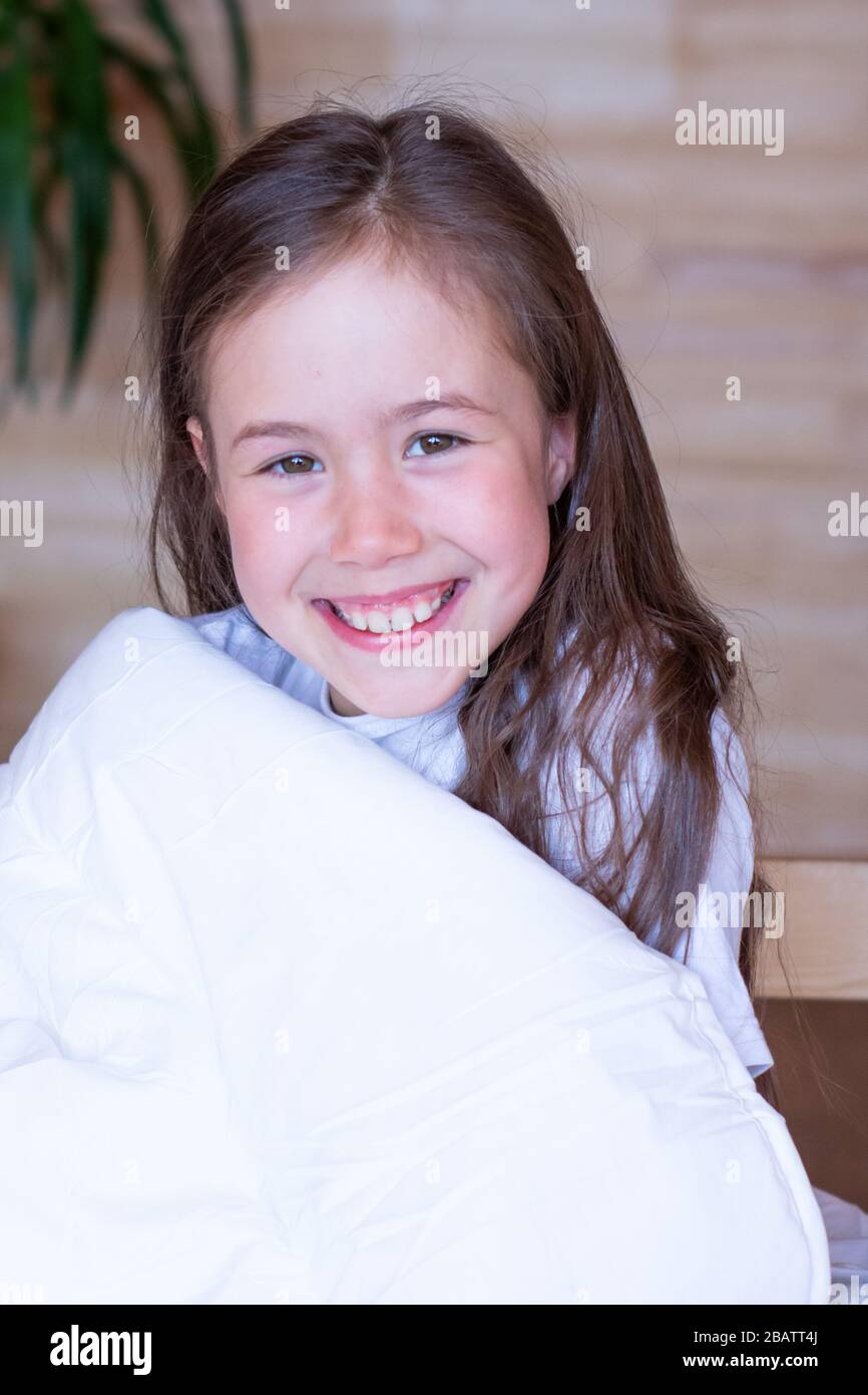 Portrait of a smiling girl waking up early in the morning in a country ...