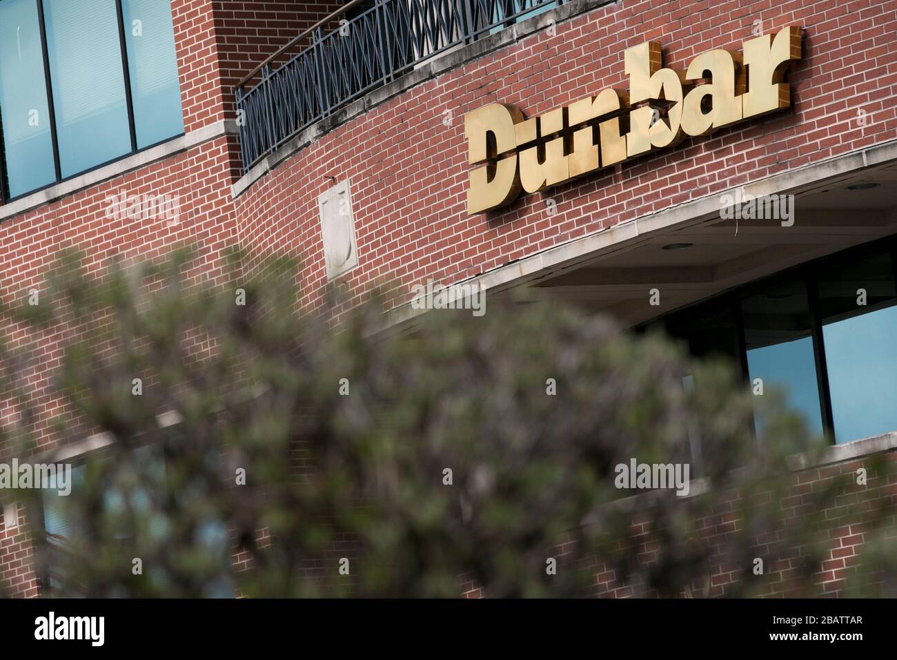 A logo sign outside of the headquarters of Dunbar Armored in Hunt ...