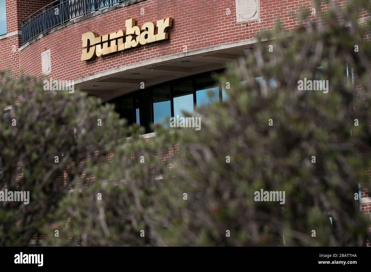 A logo sign outside of the headquarters of Dunbar Armored in Hunt ...