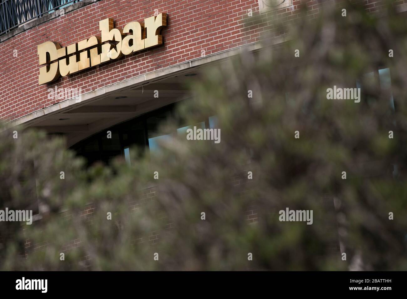 A logo sign outside of the headquarters of Dunbar Armored in Hunt ...