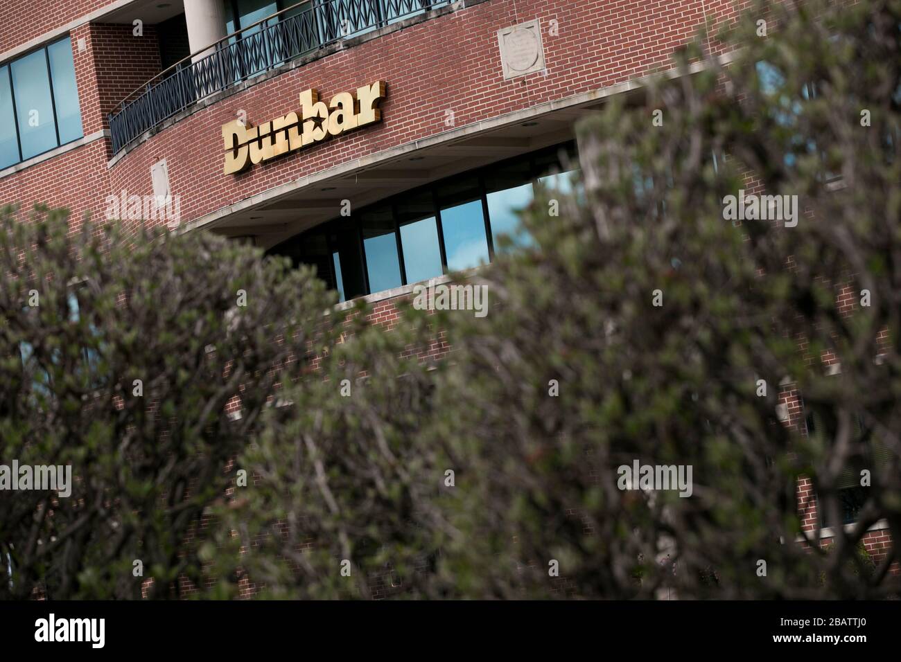 A logo sign outside of the headquarters of Dunbar Armored in Hunt ...