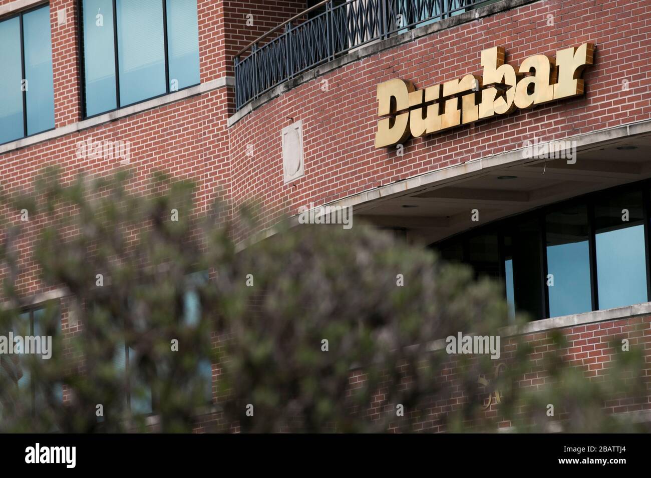 A logo sign outside of the headquarters of Dunbar Armored in Hunt ...