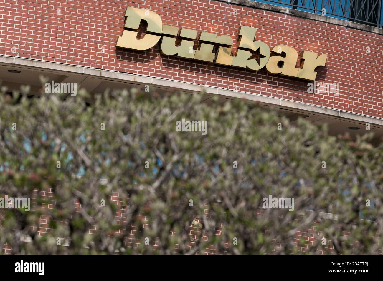 A logo sign outside of the headquarters of Dunbar Armored in Hunt ...