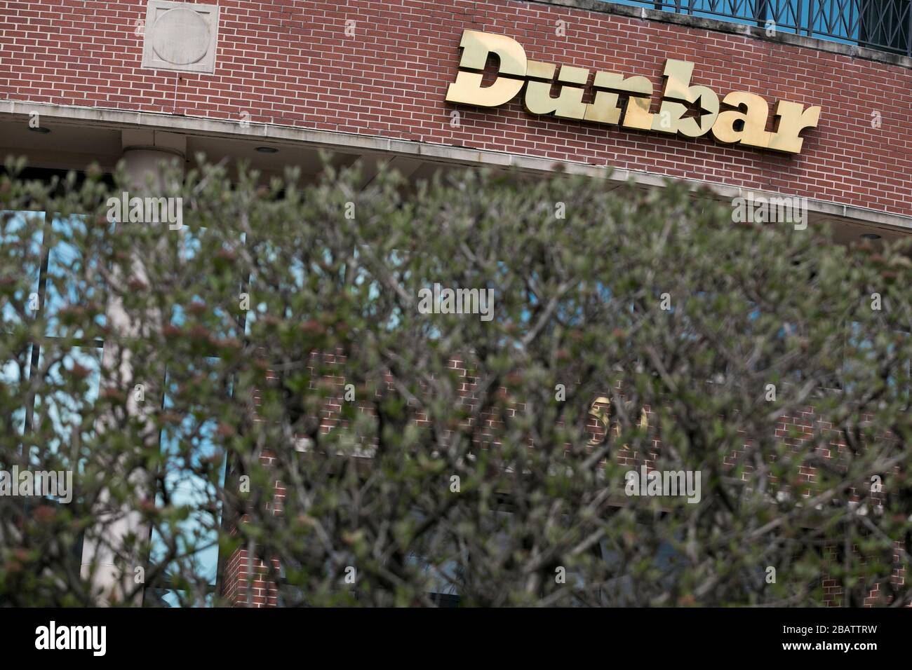 A logo sign outside of the headquarters of Dunbar Armored in Hunt ...