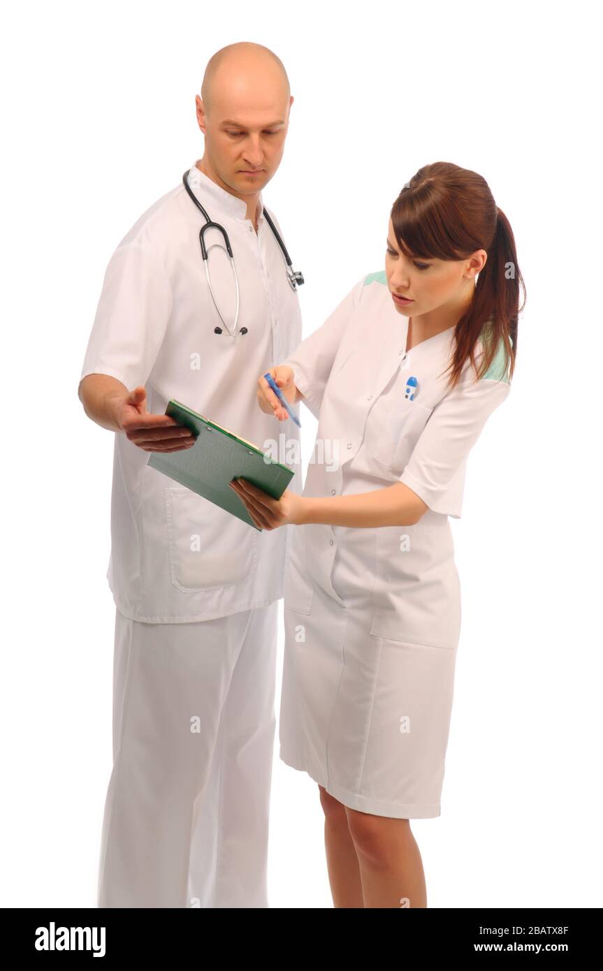 Two medical assistants discussing notes about the patient Stock Photo ...