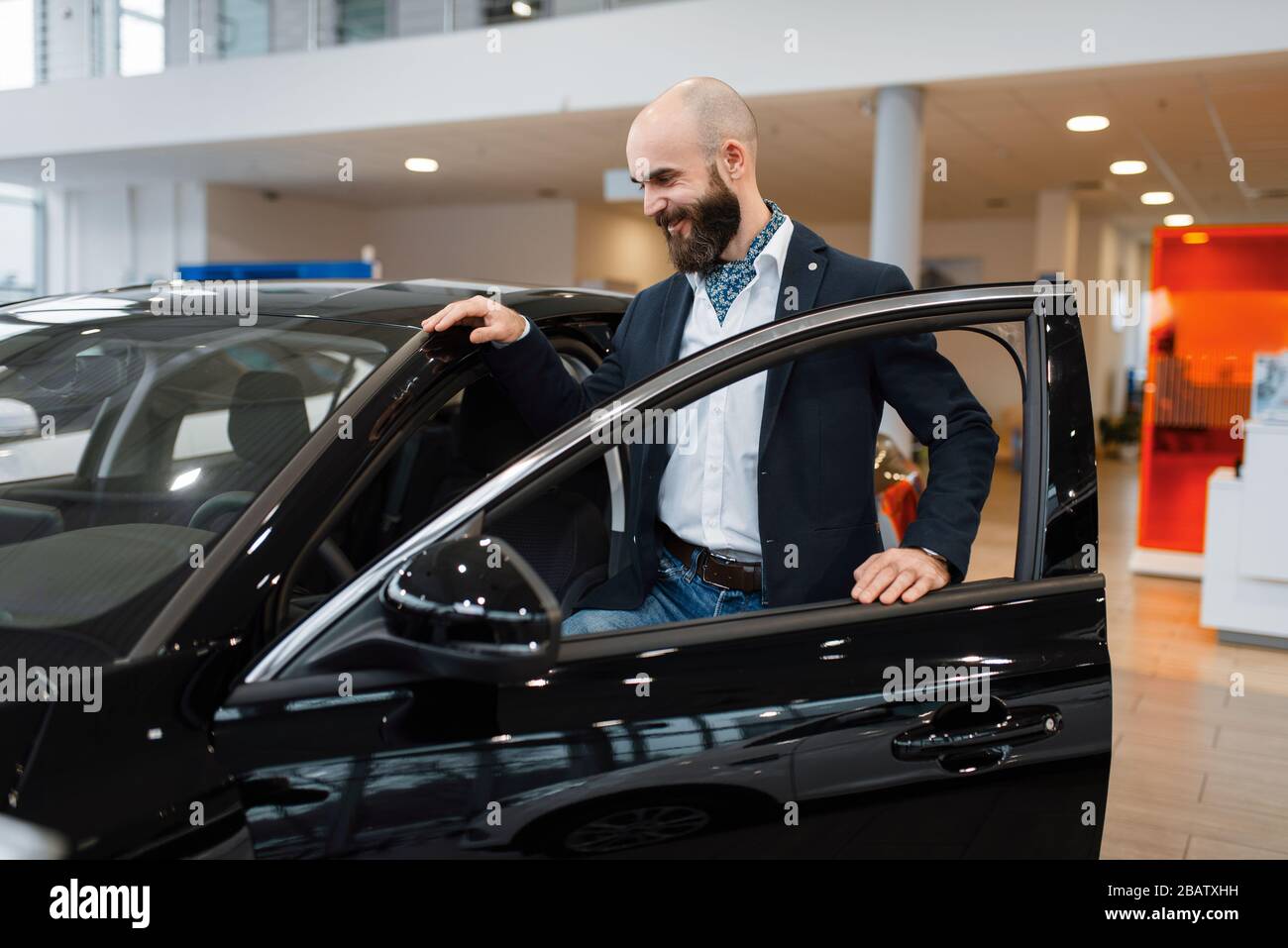 Man looking on transport interior, car dealership Stock Photo - Alamy