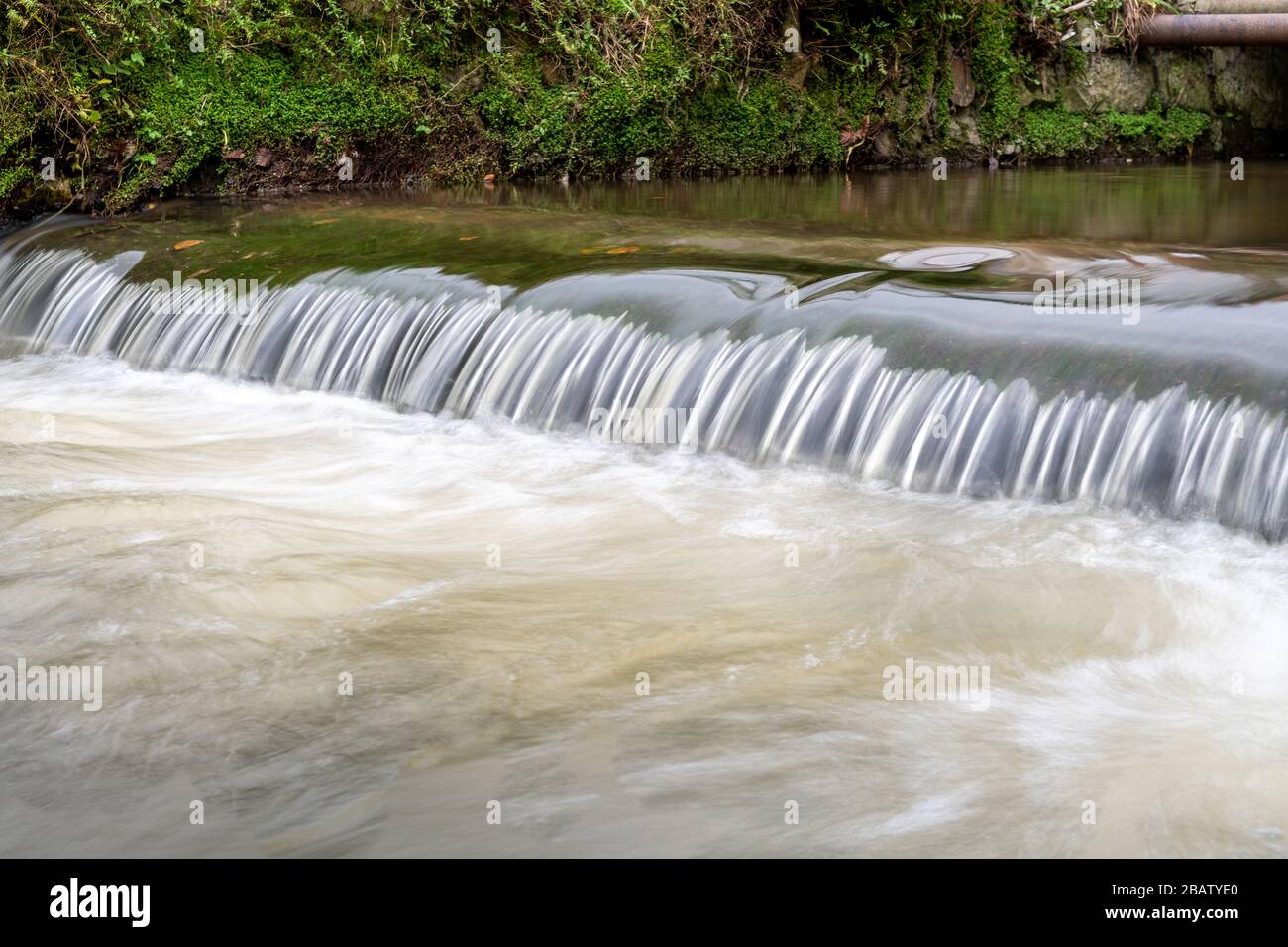 Long exposure of a watefall on the River Lim walkway at Lyme Regis in ...