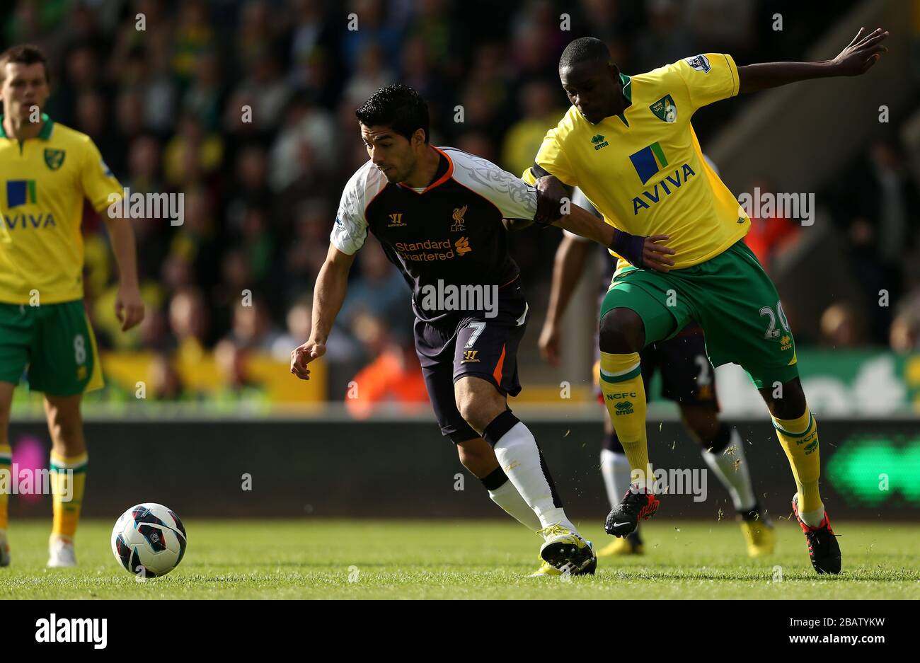 Liverpool's Luis Suarez gets away from Norwich City's Leon Barnett to ...