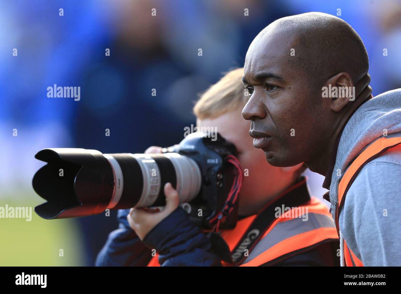 A young photographer at the game is helped by professional freelance ...