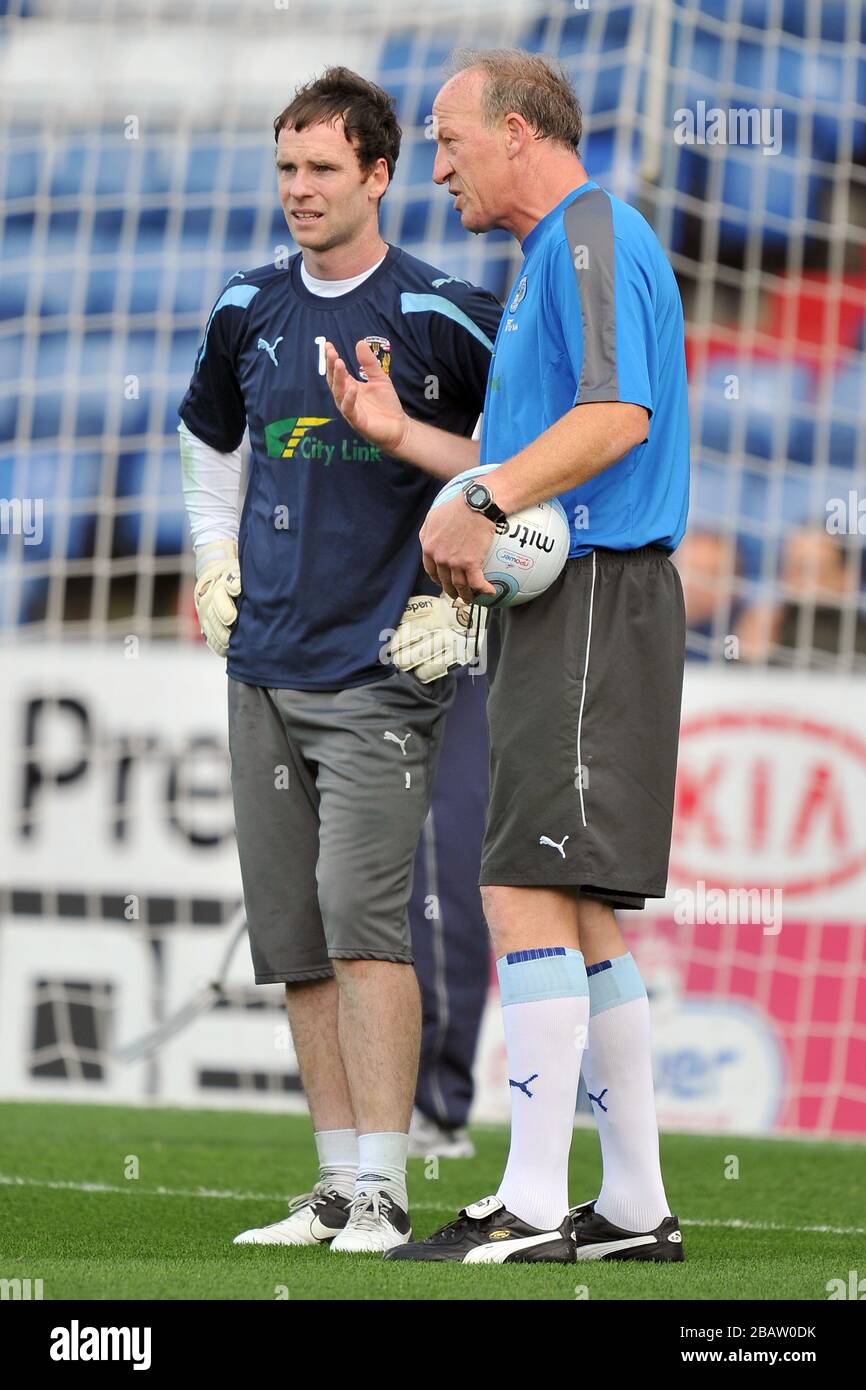 Coventry City's goalkeeping coach Steve Ogrizovic (r) speaks with ...