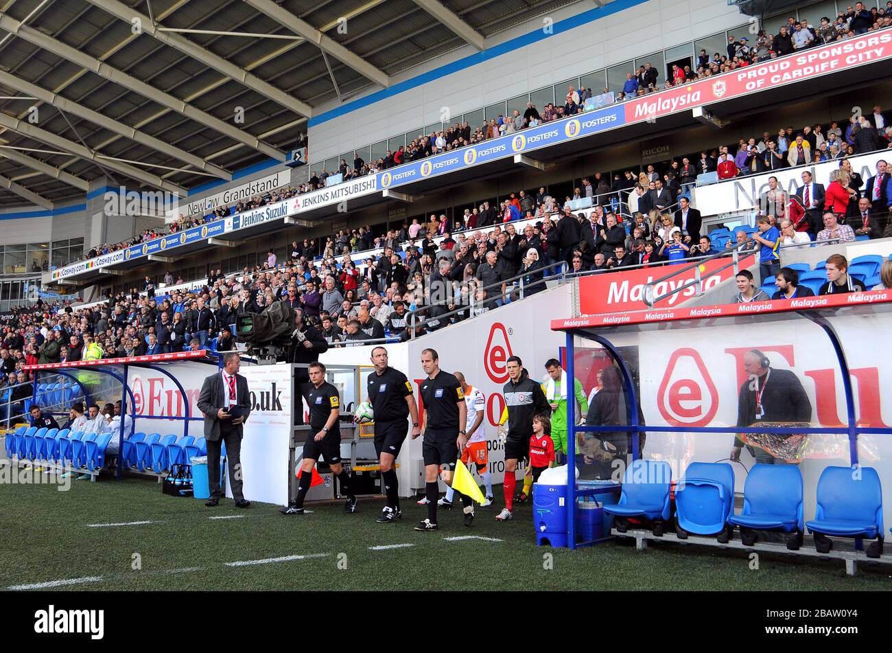 Referee Carl Boyeson and his assistants lead out the teams before the ...