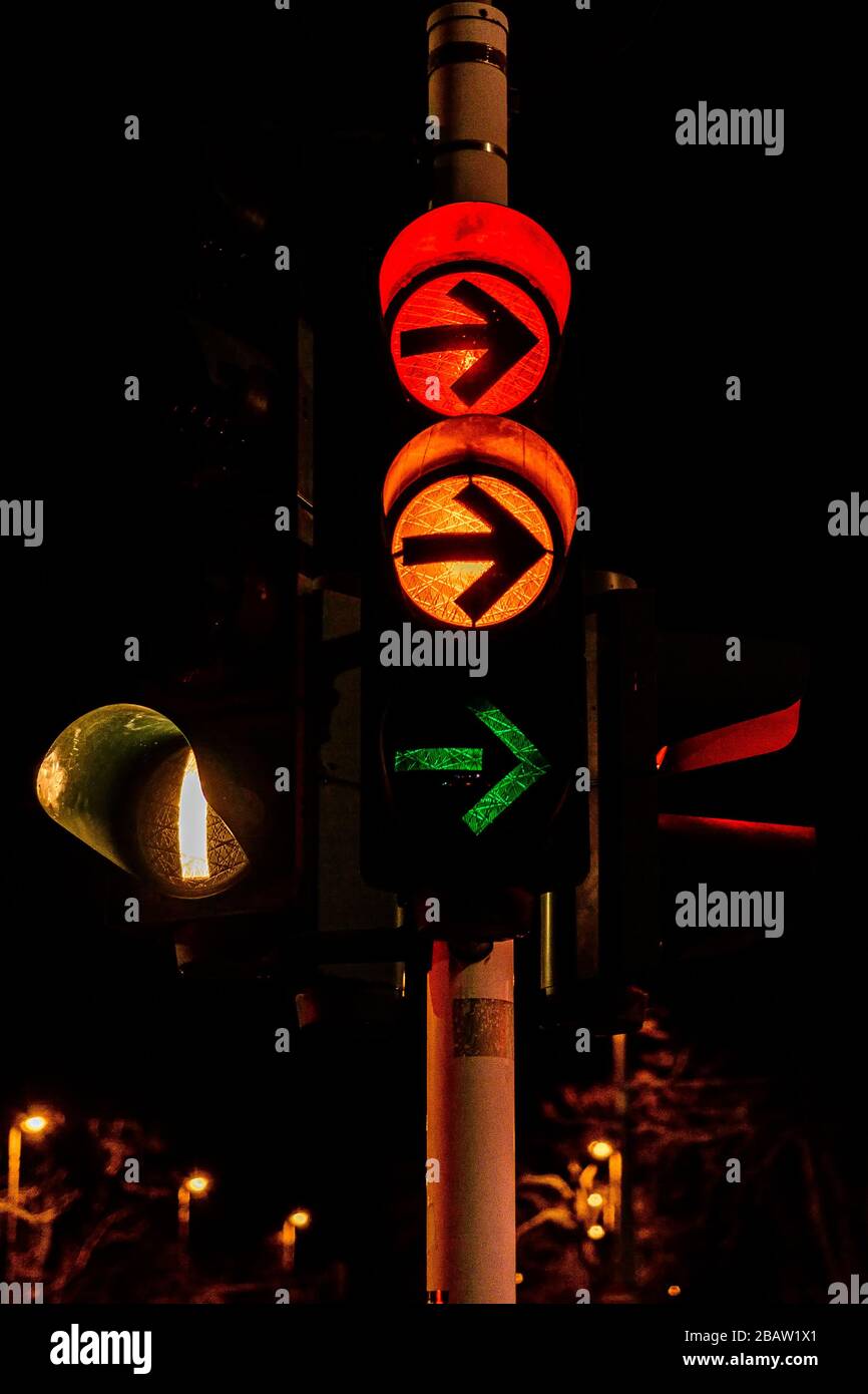 Closeup of colorful traffic lights with arrows in night city Stock ...
