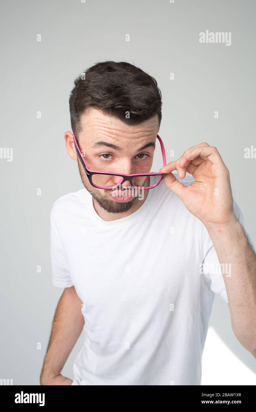 Young man isolated over background. Strange mysterious guy look on ...