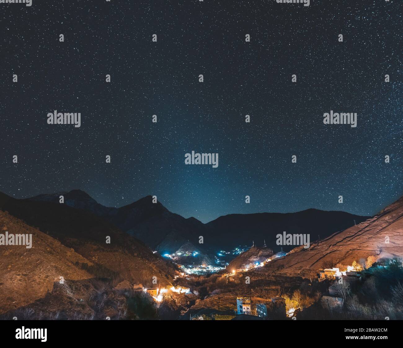 Night sky scene with the Milky Way and stars above Imlil. Small village ...