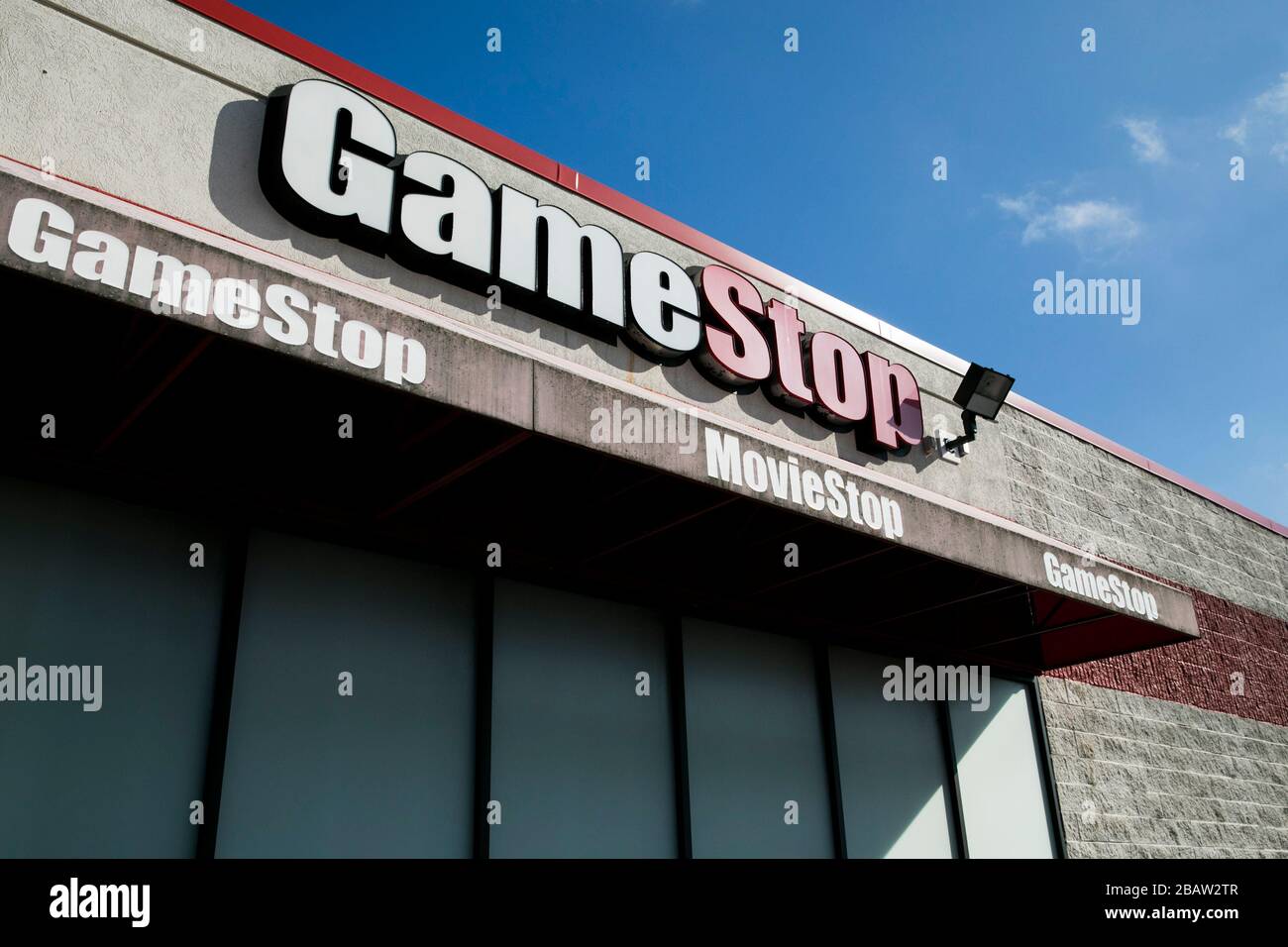 A logo sign outside of a GameStop retail store location in Towson ...