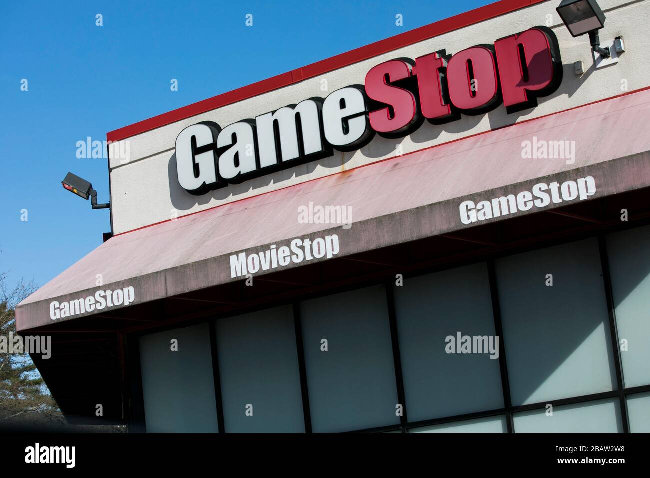 A logo sign outside of a GameStop retail store location in Towson ...