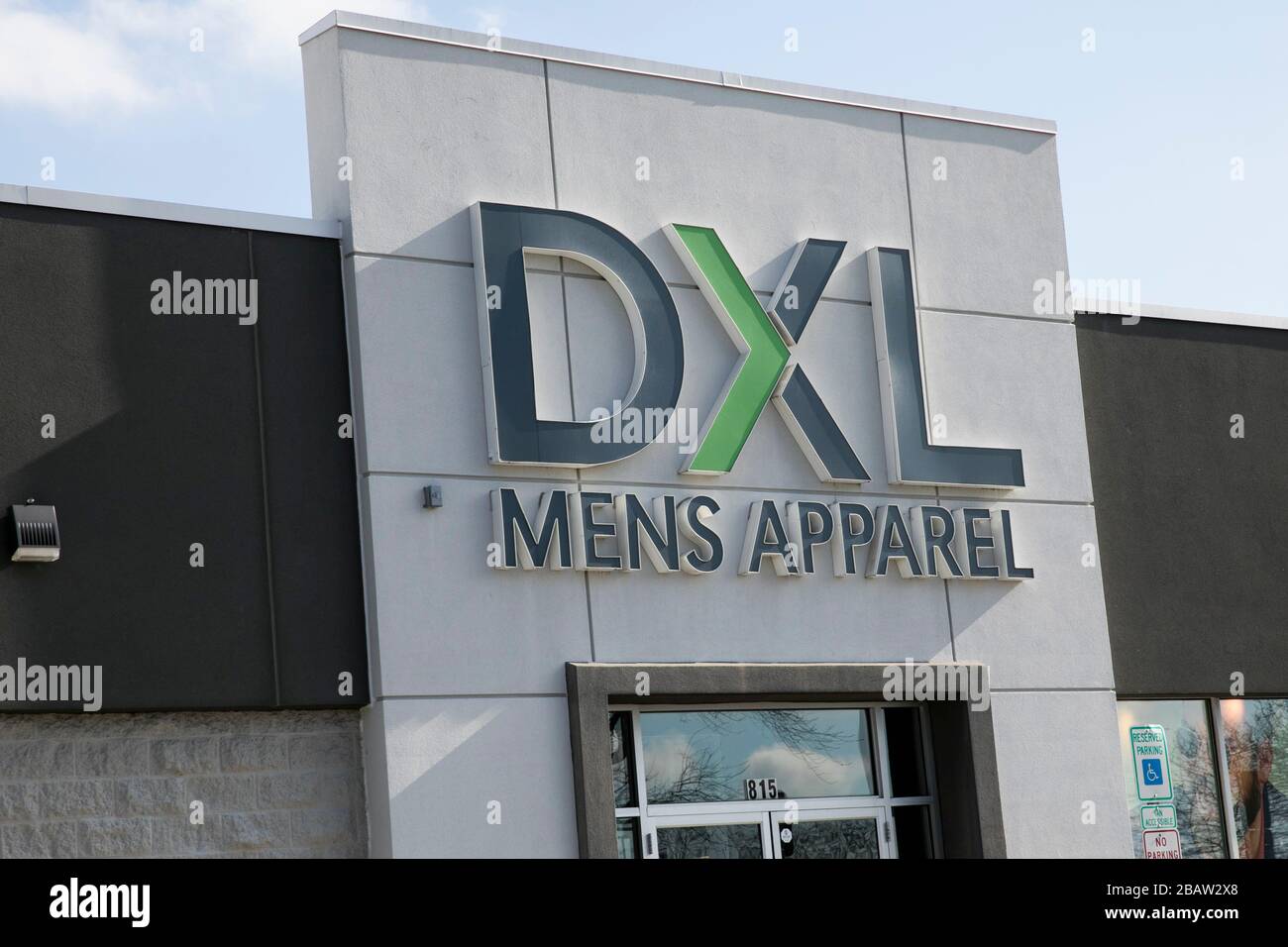 A logo sign outside of a Destination XL (DXL) retail store location in ...