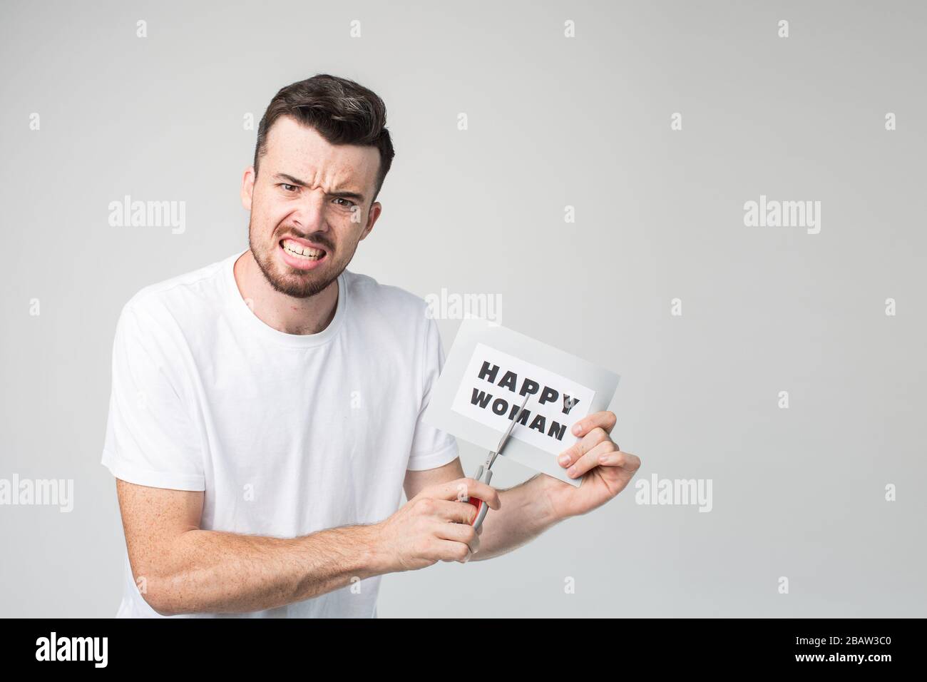 Young man isolated over background. Unhappy thoughtful emotional guy ...