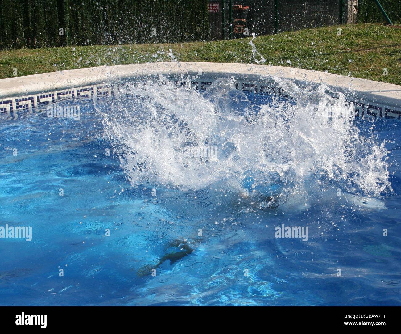 Swimming pool splash on a hot sunny August day Stock Photo - Alamy