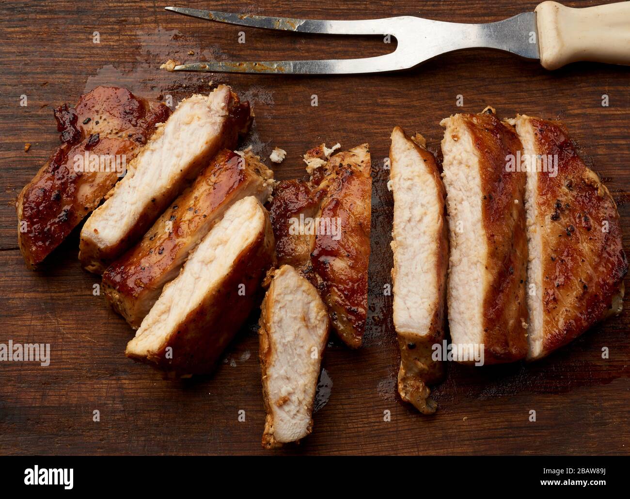 fried steak sliced on stripes on a kitchen cutting board, juicy well ...