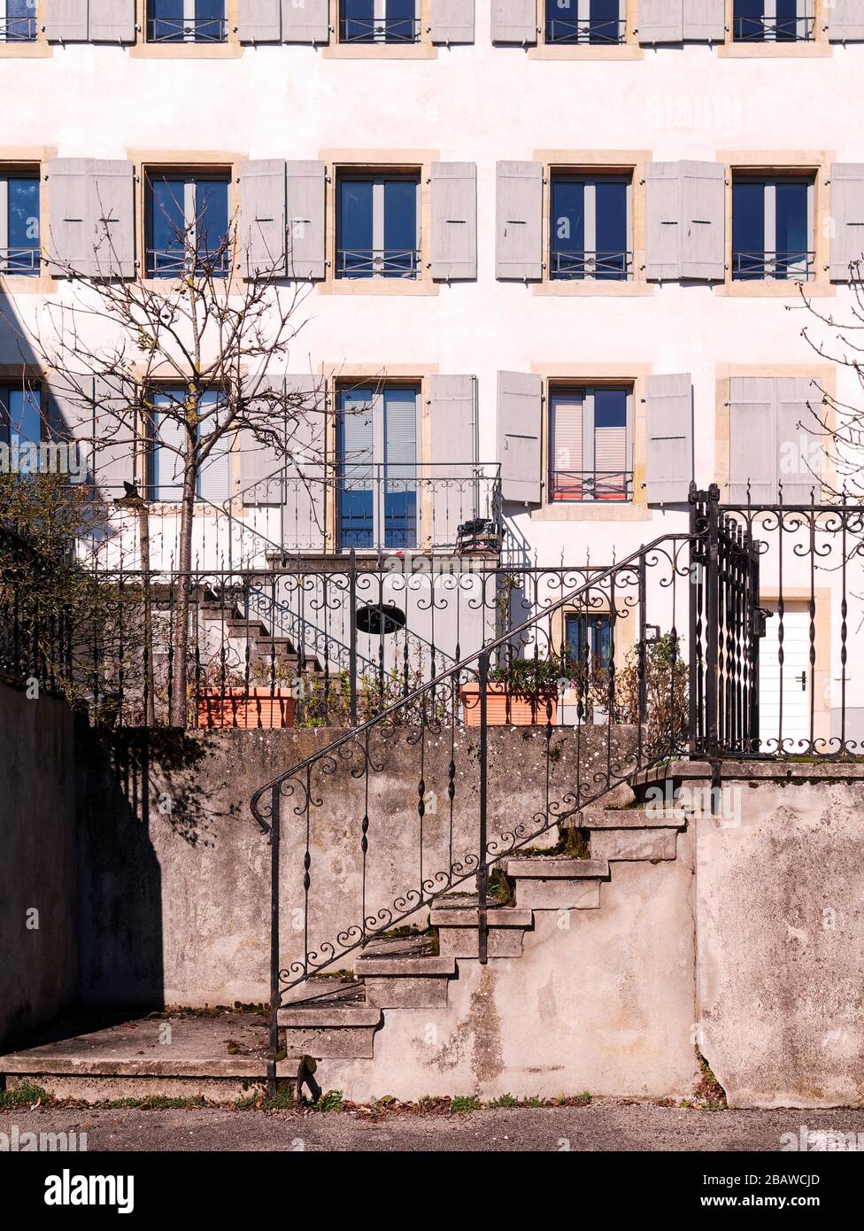 A back alley in an old town. Weathered concrete staircase with wrought ...