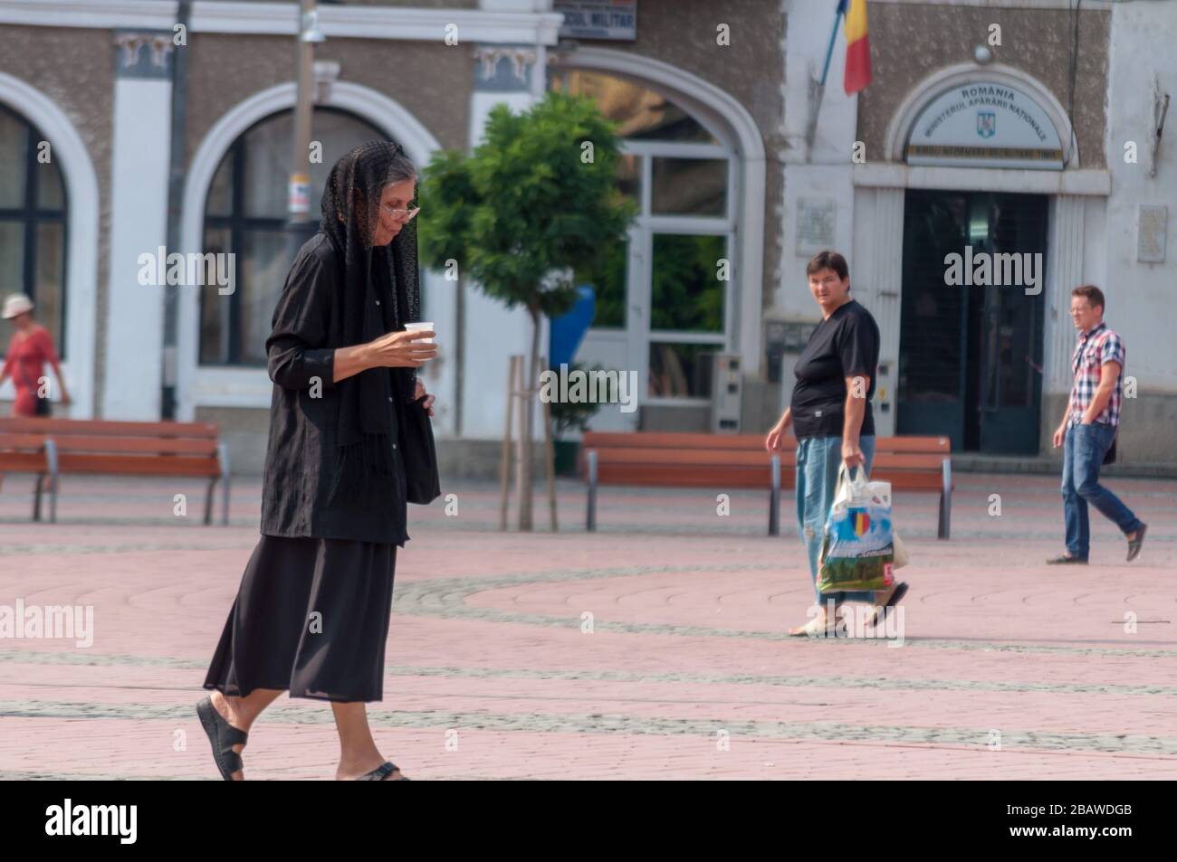 TIMISOARA, ROMANIA - SEPTEMBER 15, 2016: Woman walking on the street ...