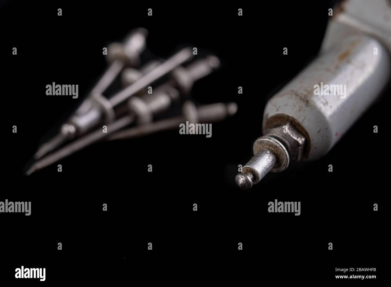 Riveting two pieces of metal sheet. Connecting steel with rivets. Dark ...