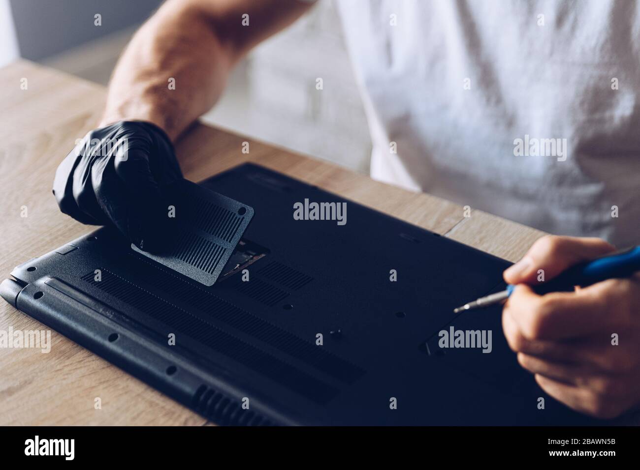 Technician installing new RAM module into the memory slot Stock Photo ...