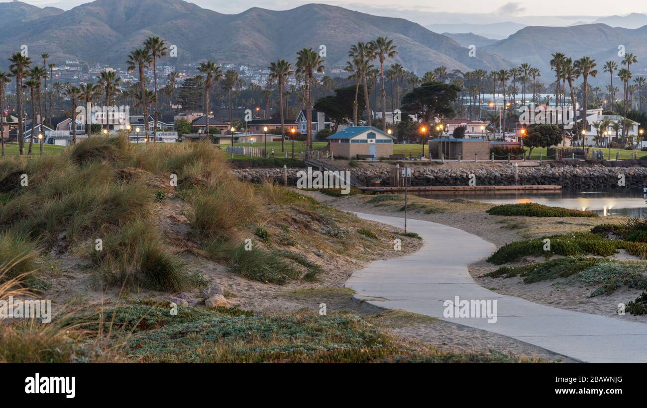 Concrete sidewalk snakes its way through the sandy dunes of Marina Park ...