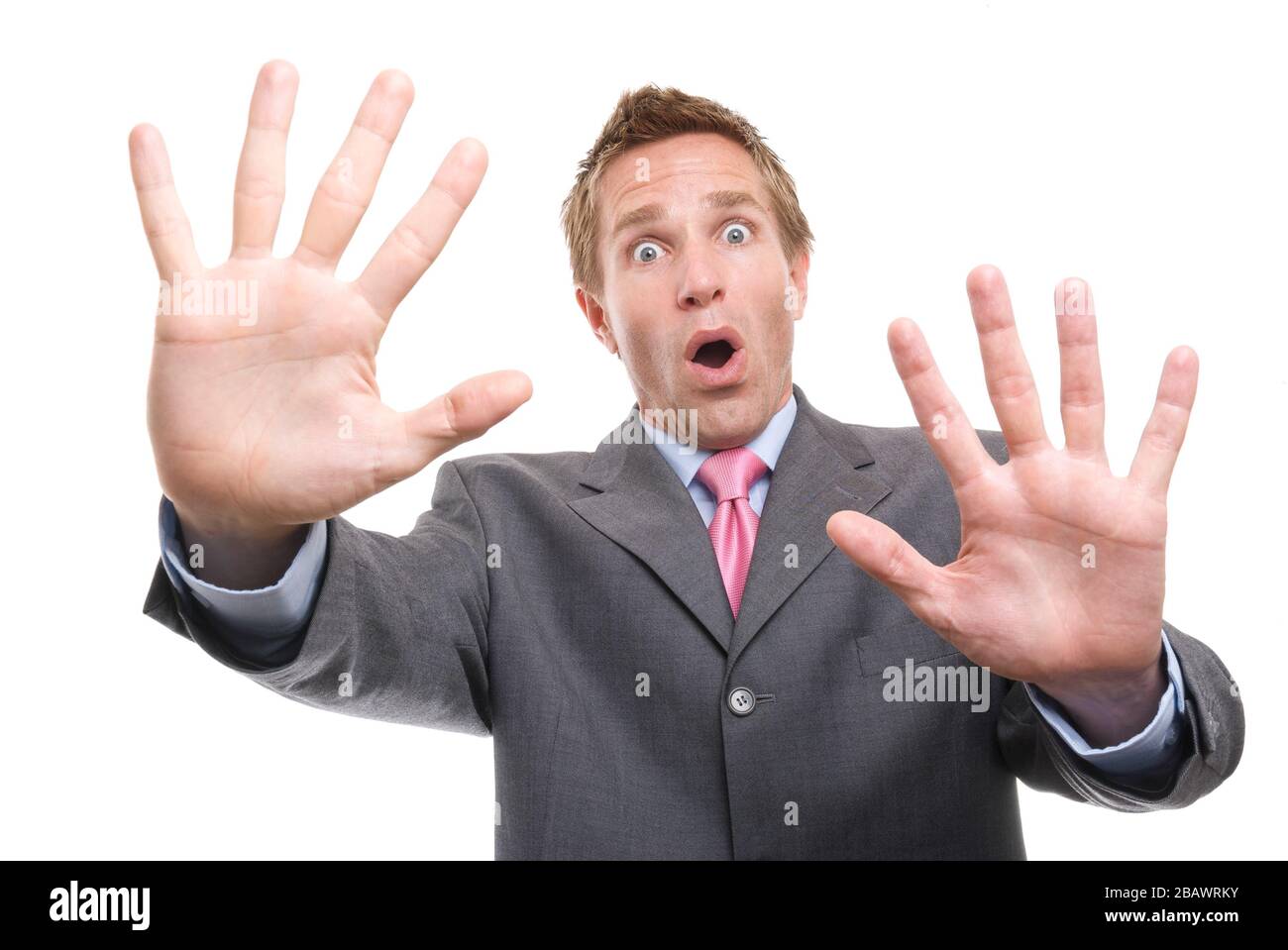 Businessman holding his hands out in a stop gesture against a white ...