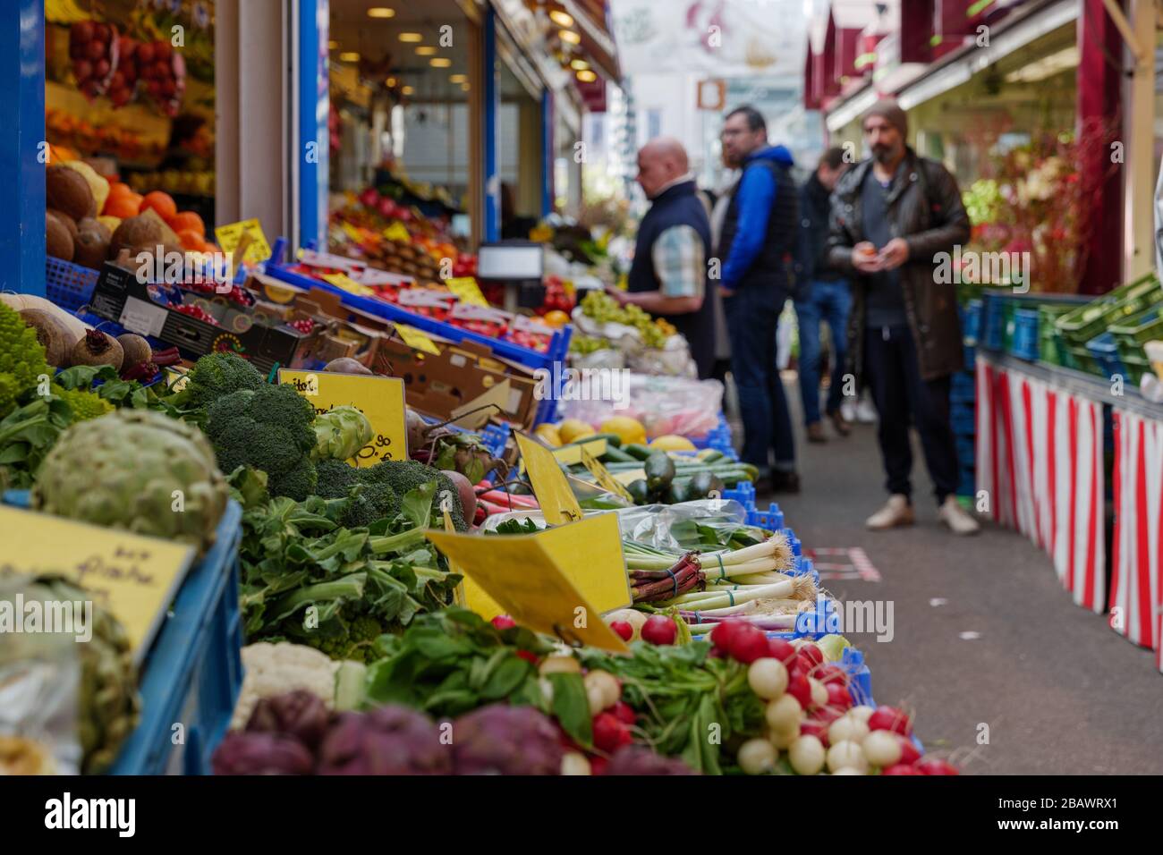 View of various vegetables sell on row of blue plastic basket in front ...
