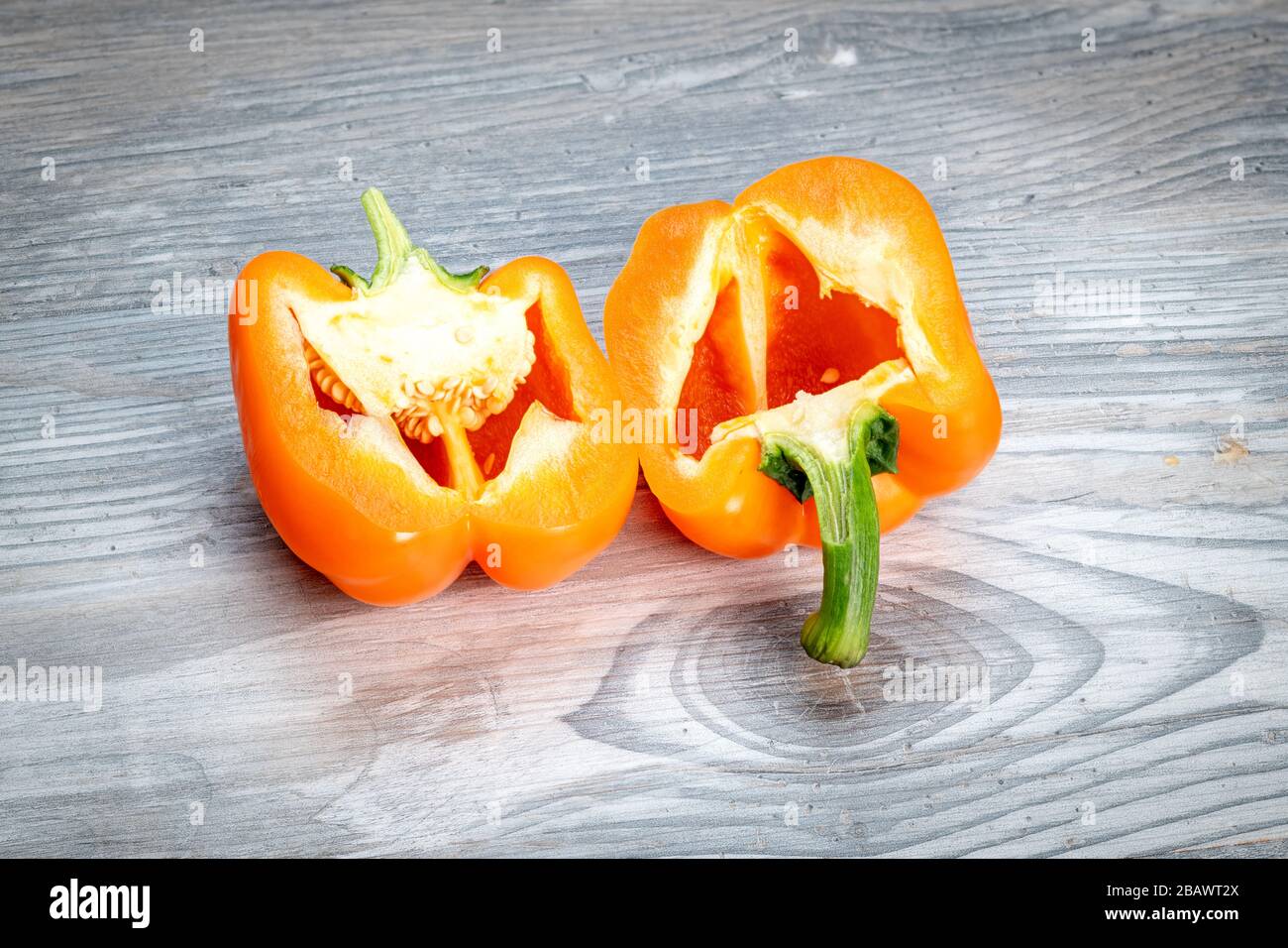 Bell pepper cut in half on a tabletop Stock Photo - Alamy