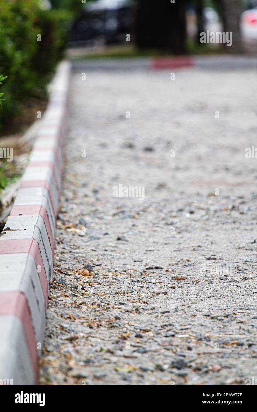 Installation of a curb made of concrete blocks, road repair in the ...