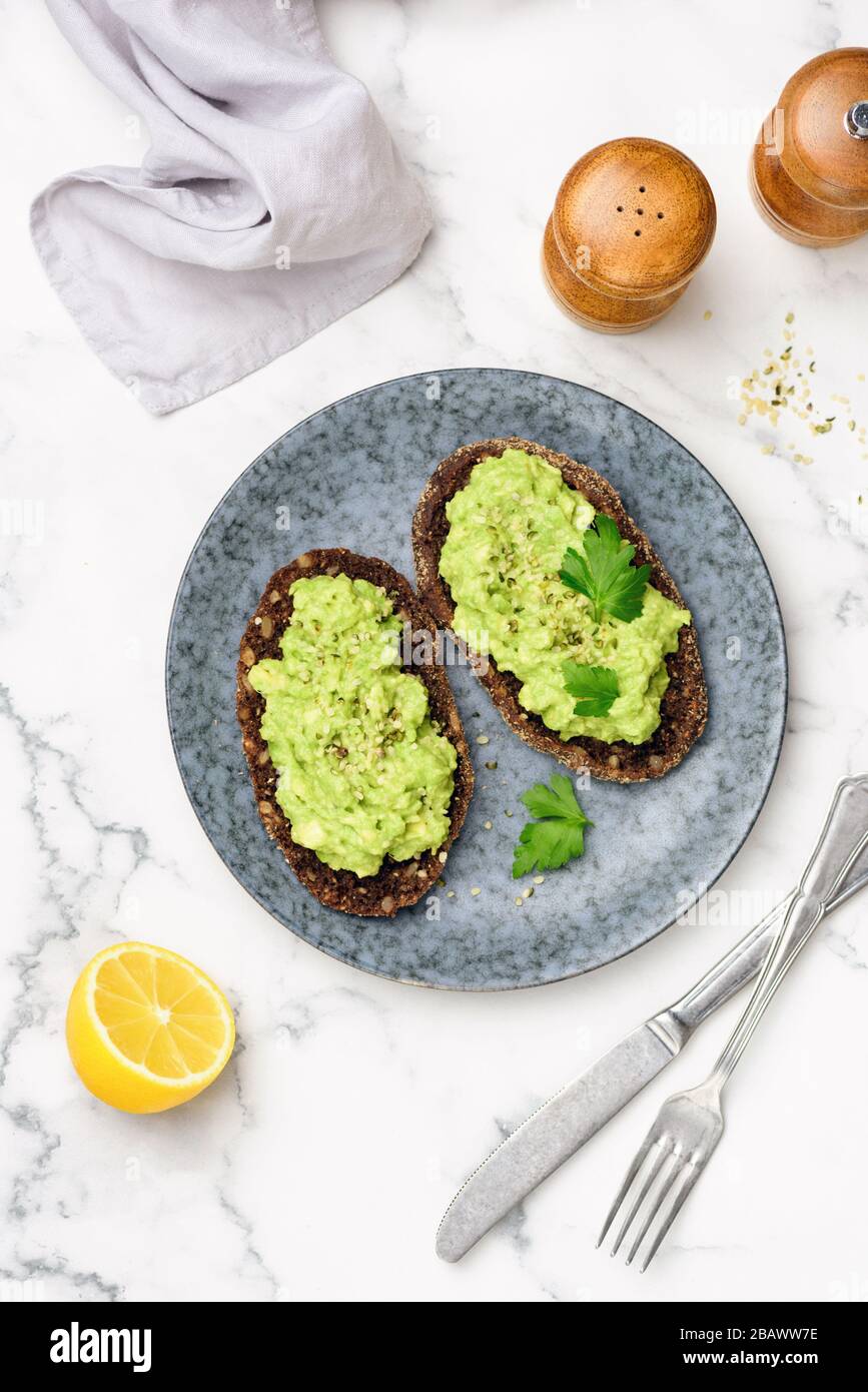 Rye bread toast with mashed avocado cream. Vegan avocado toast with ...