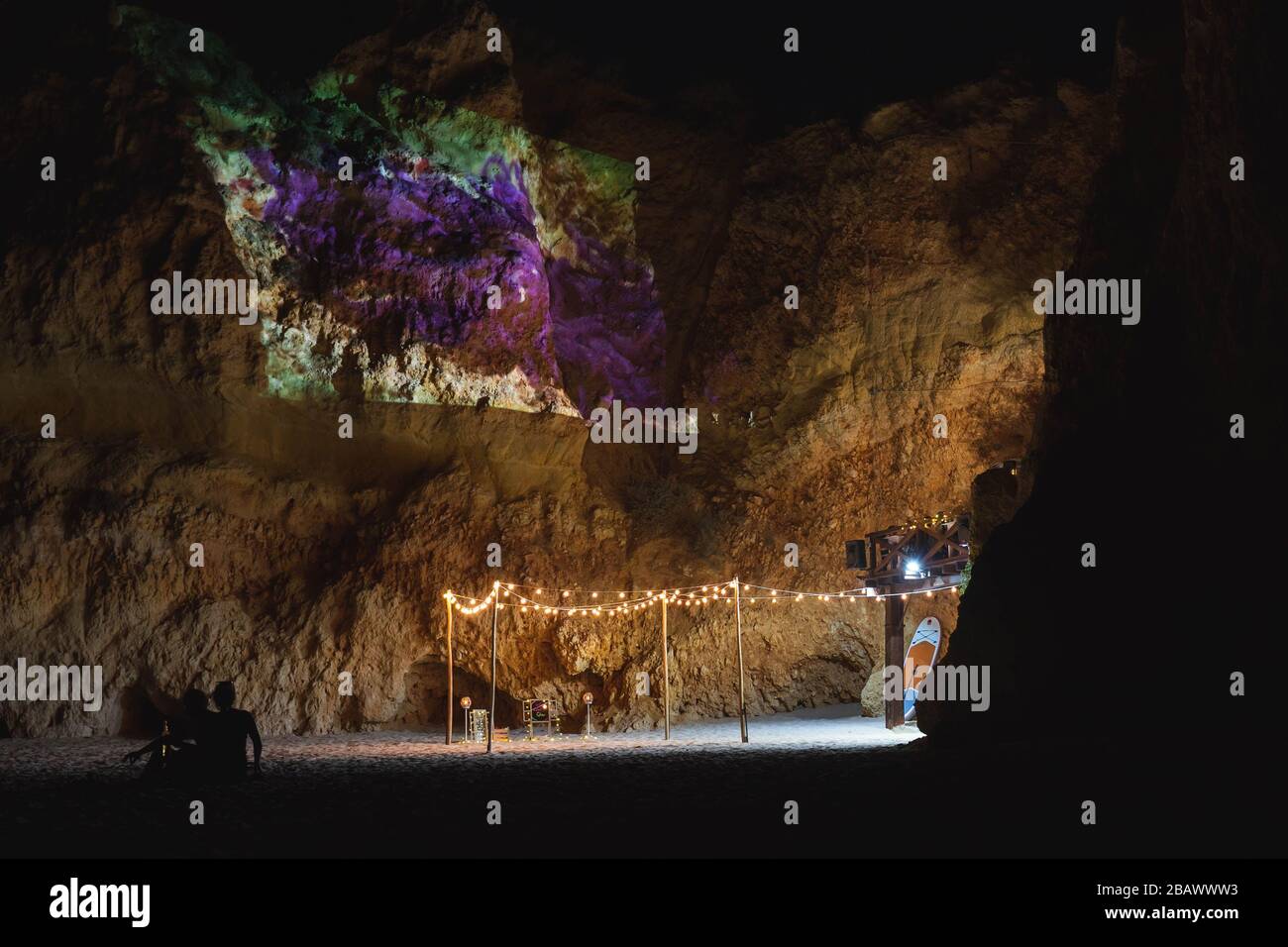 open air cinema with projector on the beach. people watching movie ...