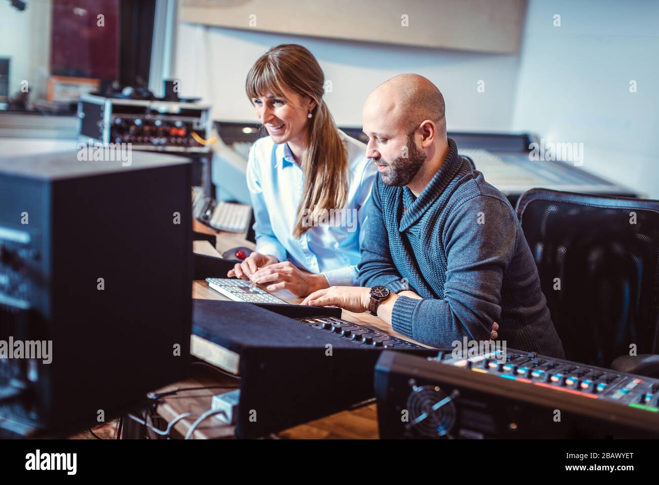 Singer or artist and sound engineer working in the studio Stock Photo ...