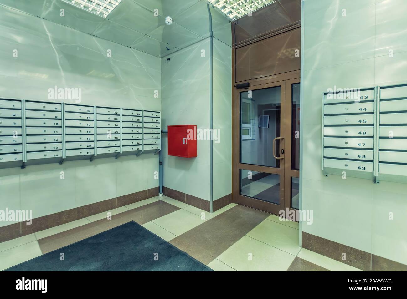 Empty hall mailboxes and doors at new apartment building Stock Photo ...