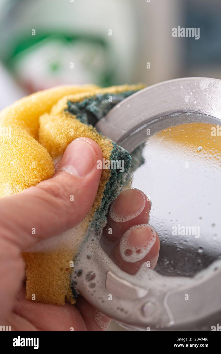 Hand washing with a rub glass crockery close up Stock Photo - Alamy