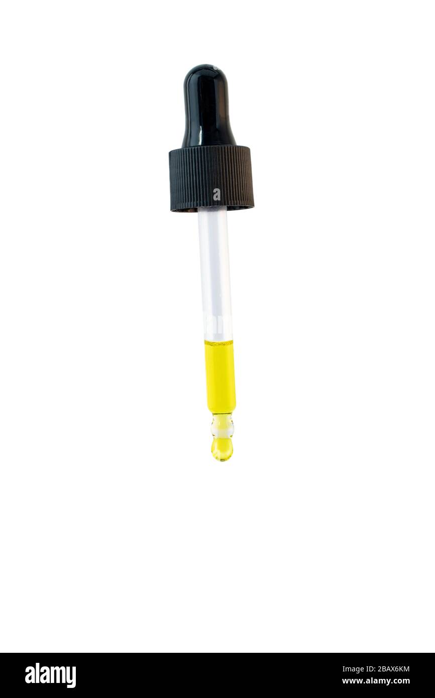 Oil drop in the glass dropper isolated on white. Pipette liquid dosage ...