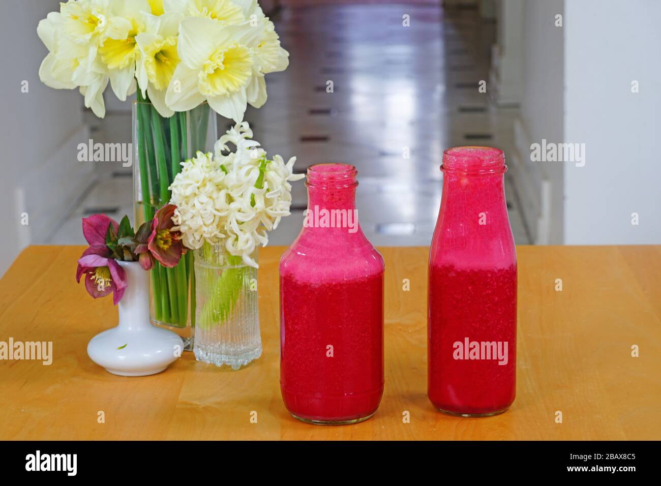 Glass bottles filled with colorful homemade beet smoothies Stock Photo ...